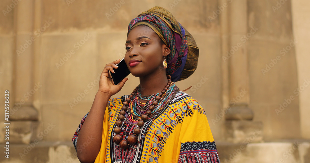 Beautiful young charming African woman in the traditional outfit and ...