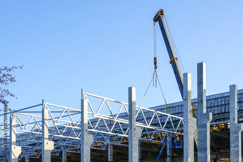 construction of the body of a modern factory, assembly of metal trusses ...