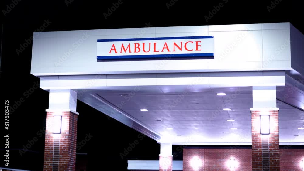 Night time video of emergency ambulance sign outside hospital emergency ...