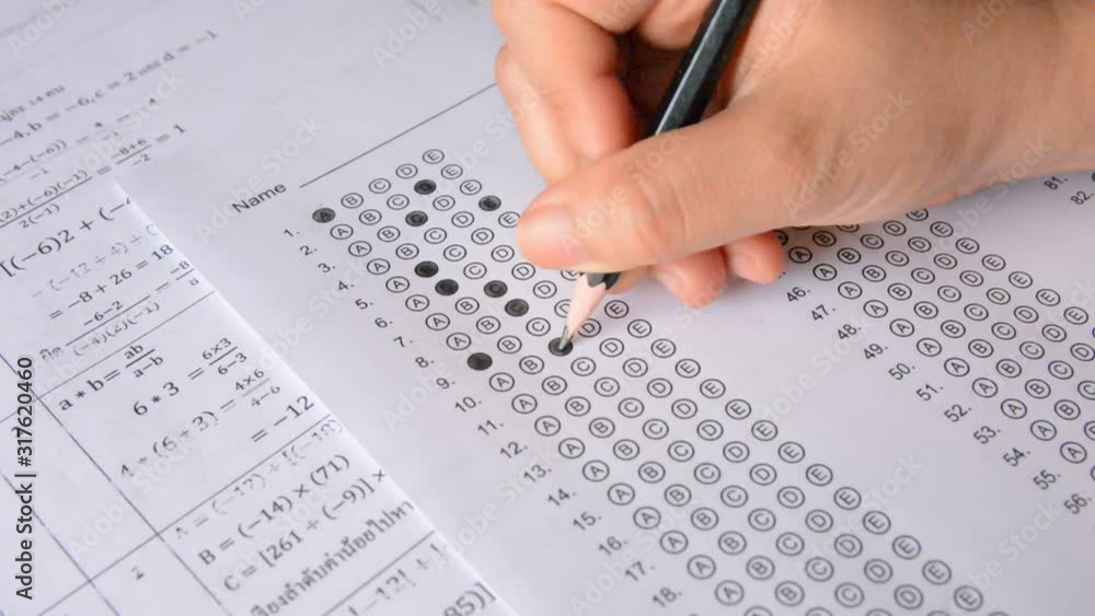 the student fills in answers on the standardized multiple choice test ...