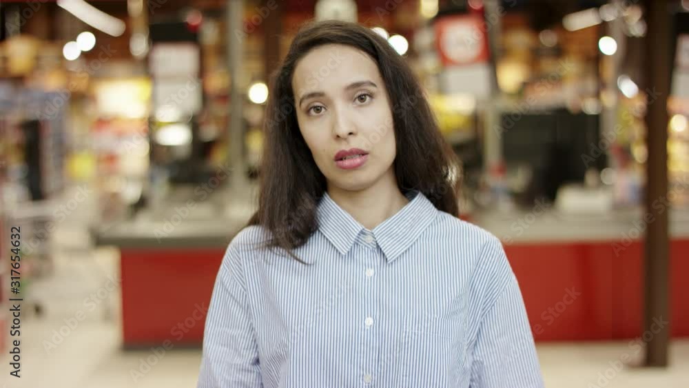 Lovely girl in supermarket being frustrated, feeling unhappy, rising ...