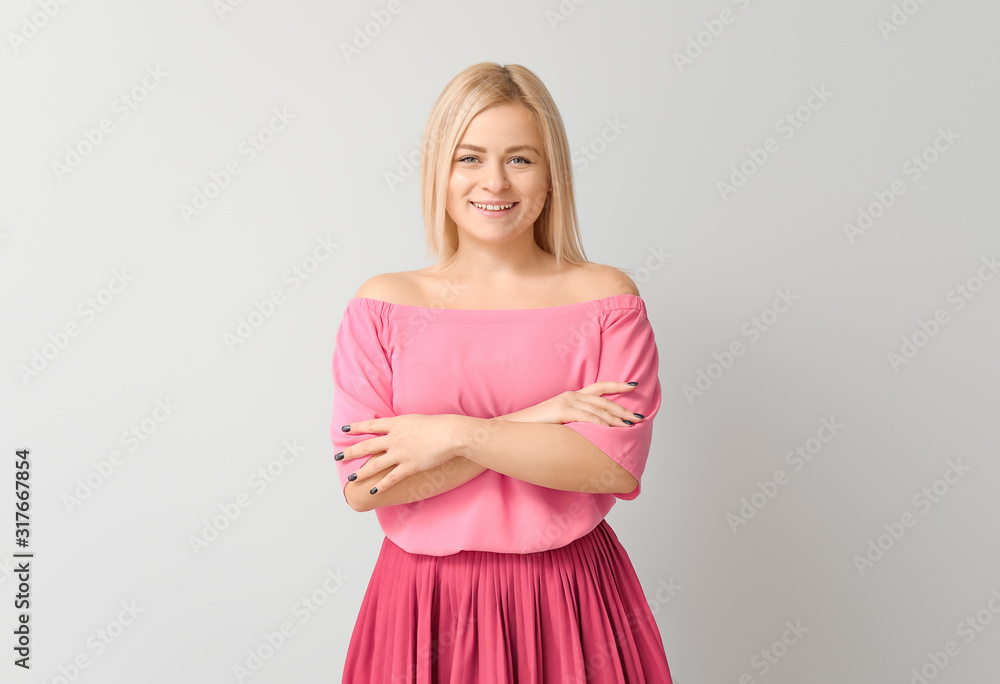 Beautiful young woman on light background Stock Photo | Adobe Stock
