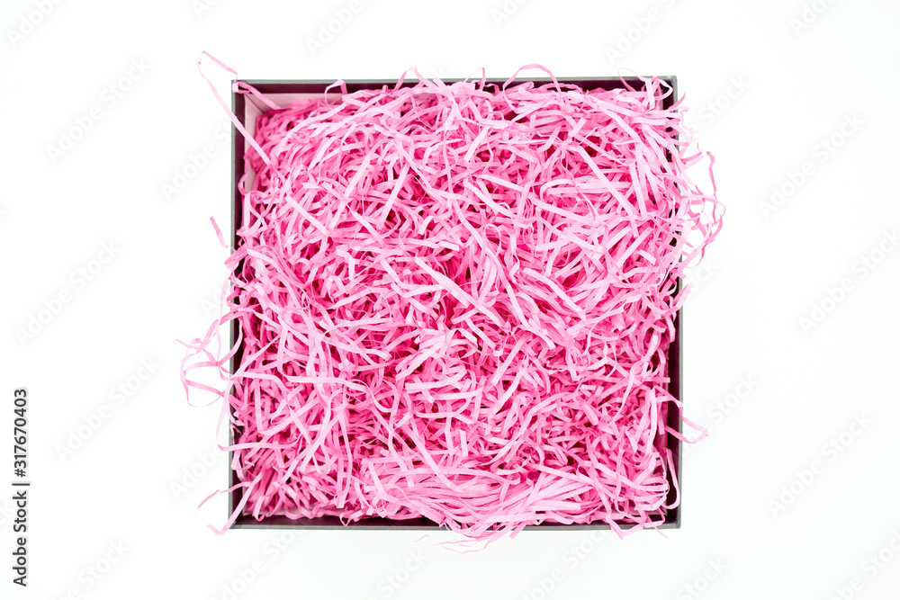 Shredded pink paper packing material in a square box. Pink spaghetti ...