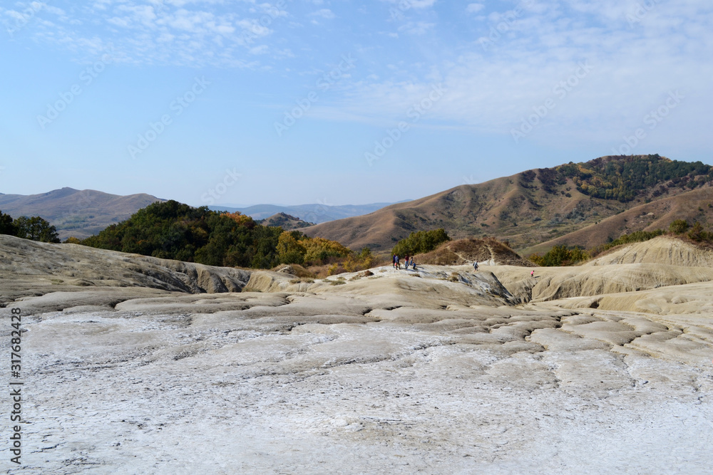 Landscape from the mud volcanoes with hills in the distance and dry mud ...