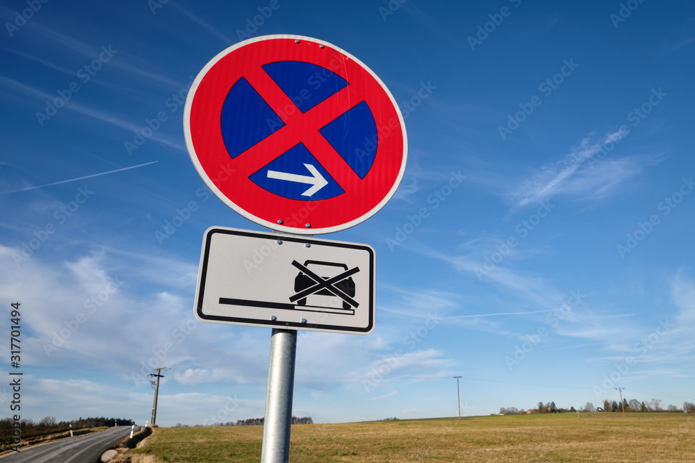 Red and blue traffic sign in front of beautiful blue sky and ...