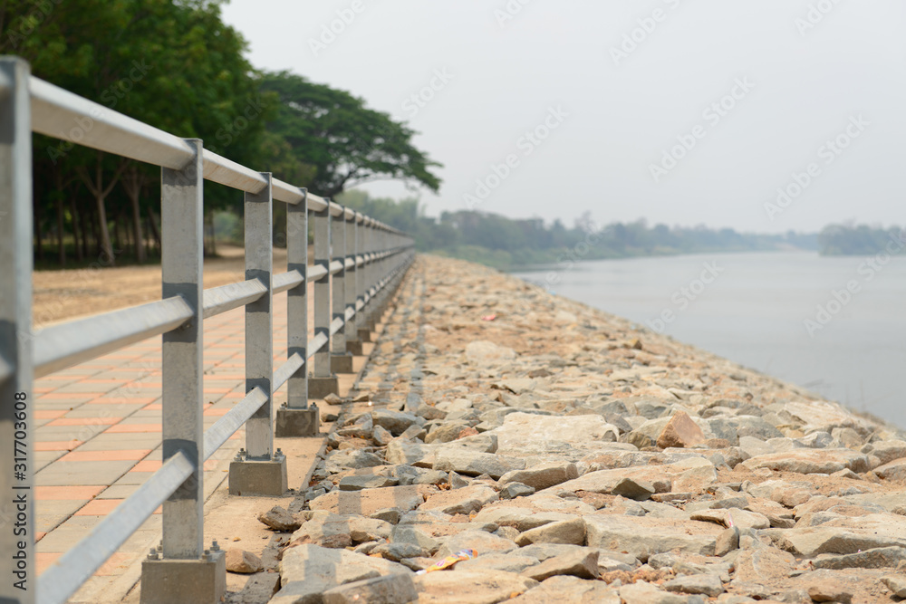 The fence edge and the rock embankment are used for reinforce a ...