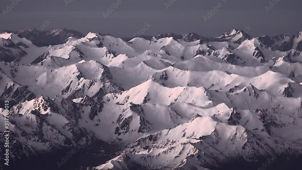 Snowy high altitude mountain ranges from airplane window. Caucasus ...
