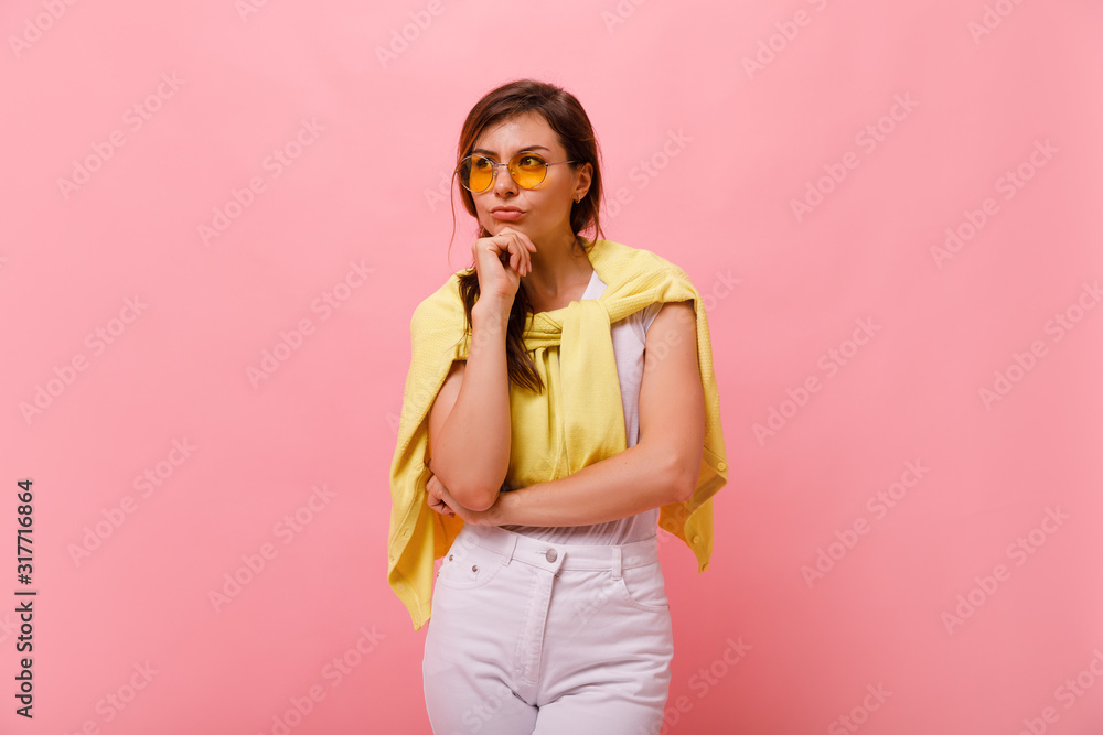 Pensive, serious-looking focused caucasian woman in denim jacket ...