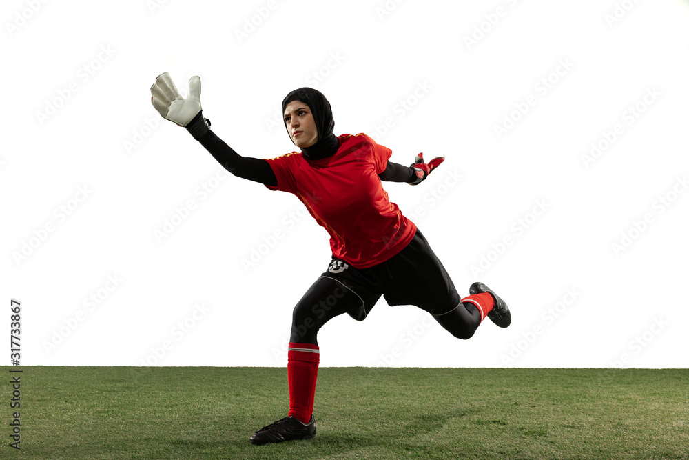 Arabian female soccer or football player, goalkeeper on white studio ...