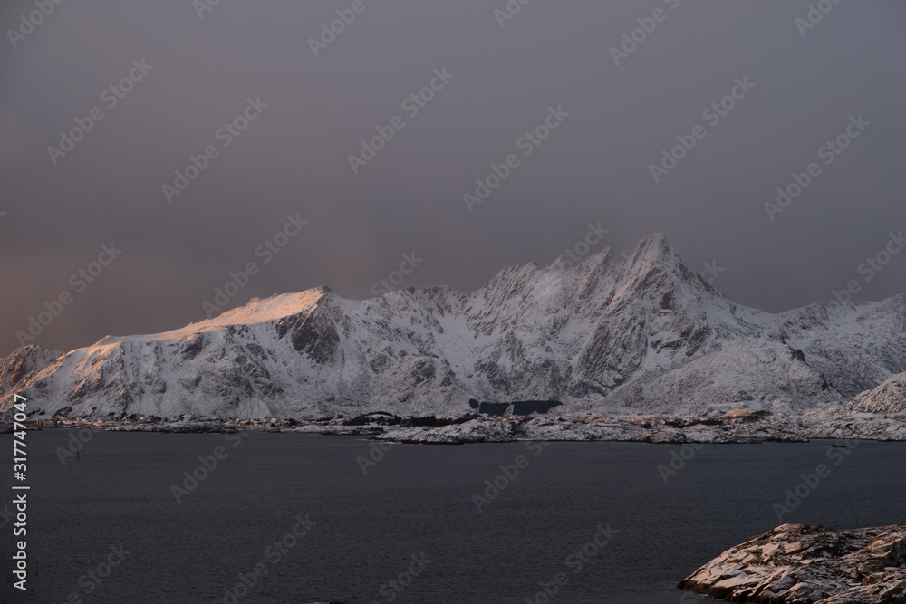 typical lofoten islands view. fishin town with mountains in backround ...