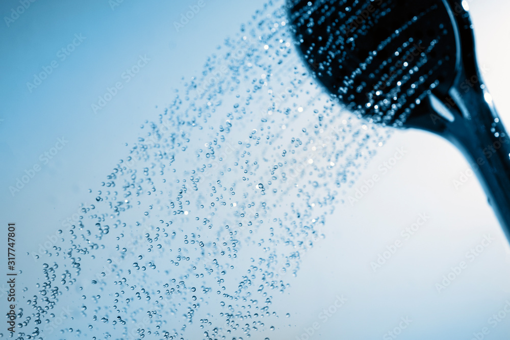 Shower head and falling water drops. Stock Photo | Adobe Stock