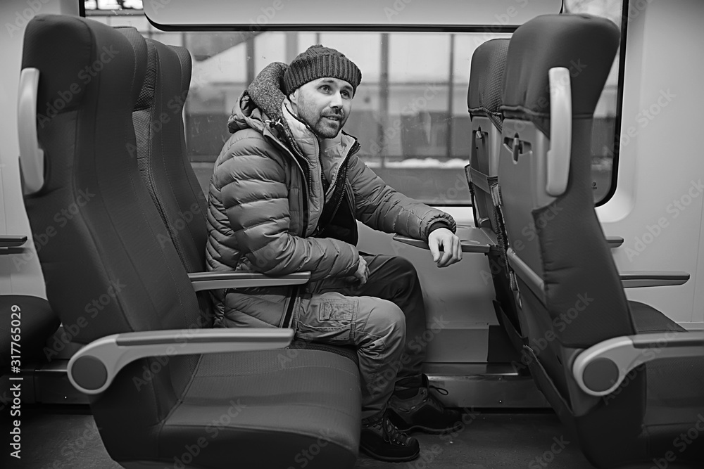 man sits by the window in the train / concept of transport people ...