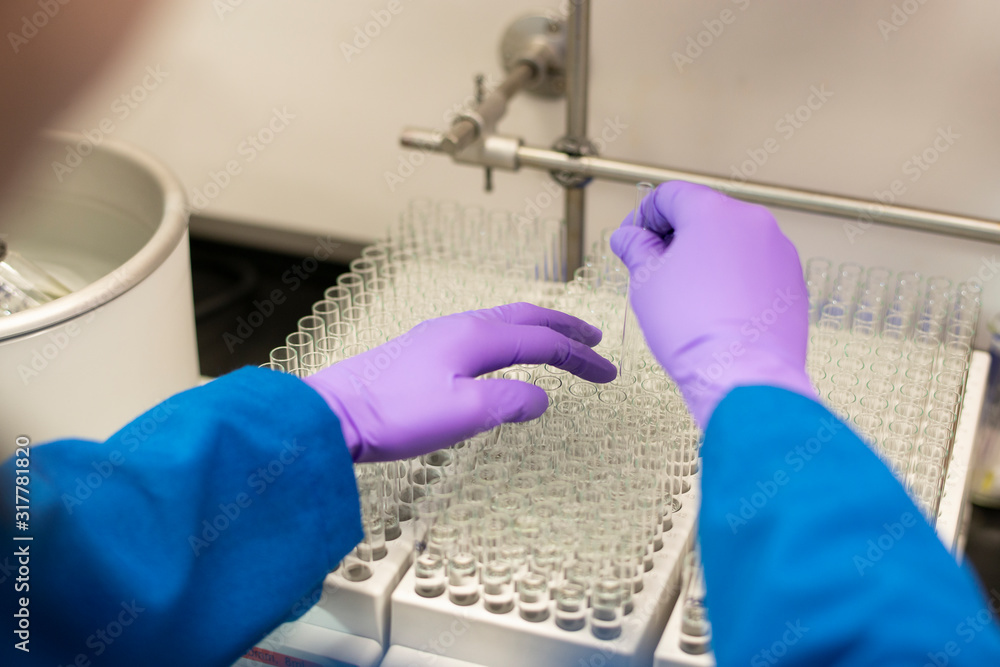 Using glass syringe to fill test tubes Stock Photo | Adobe Stock