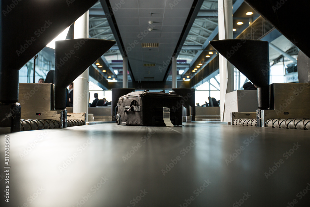 baggage at the airport moves along the conveyor to the luggage ...