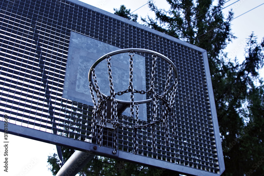 Urban sport terrain. Metal basketball with hoop and steel chains net in ...