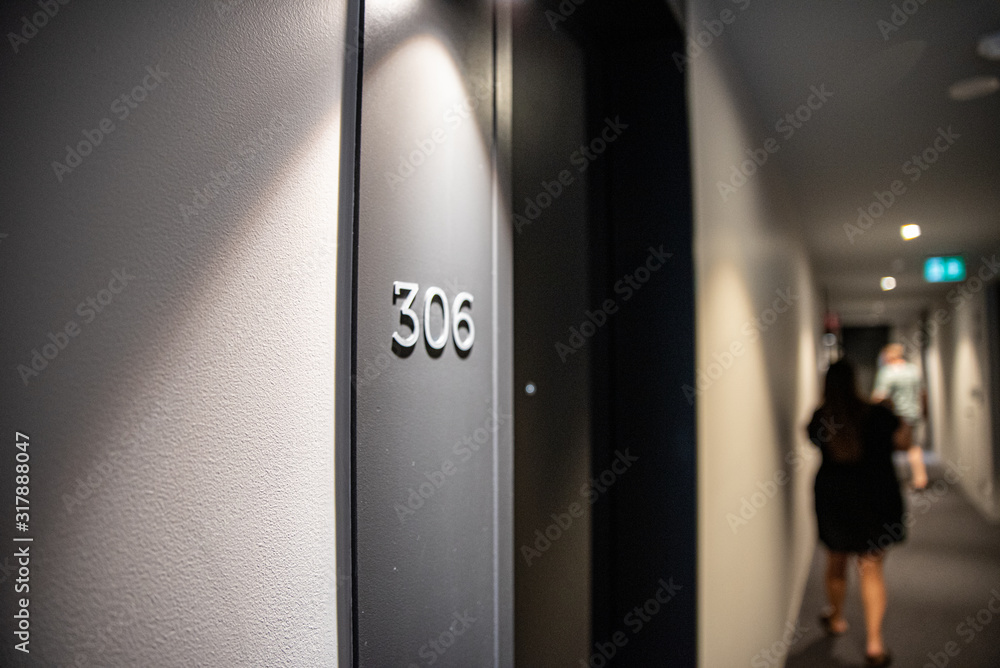 door number 306 under a mysterious light with people walking down it ...