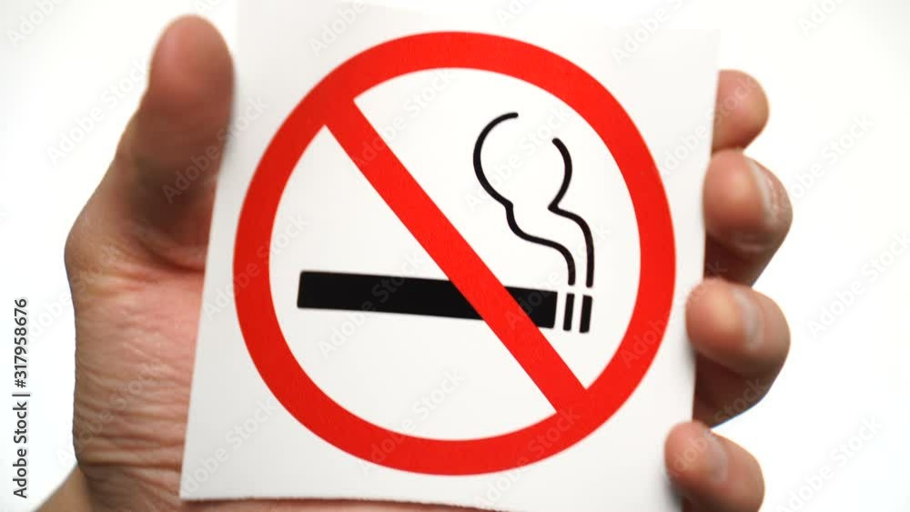 No smoking allowed sign isolated. Male hand holding no smoking sign ...