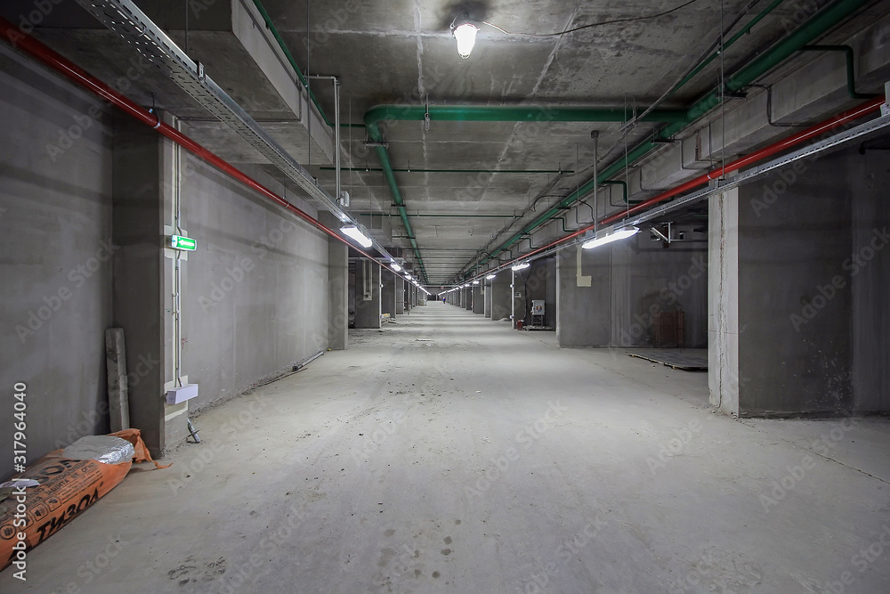 Underground parking in construction phase. Empty garage in basement of ...