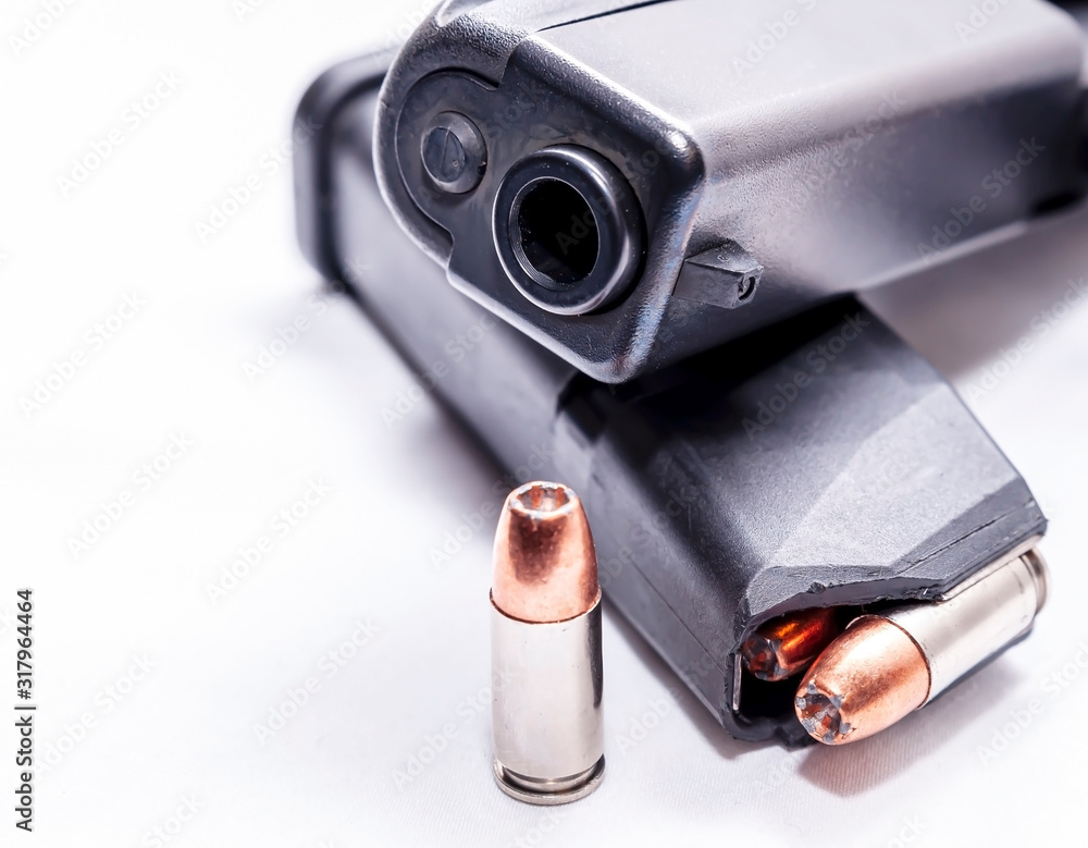 A black 9mm semi automatic pistol with a loaded pistol magazine with a ...