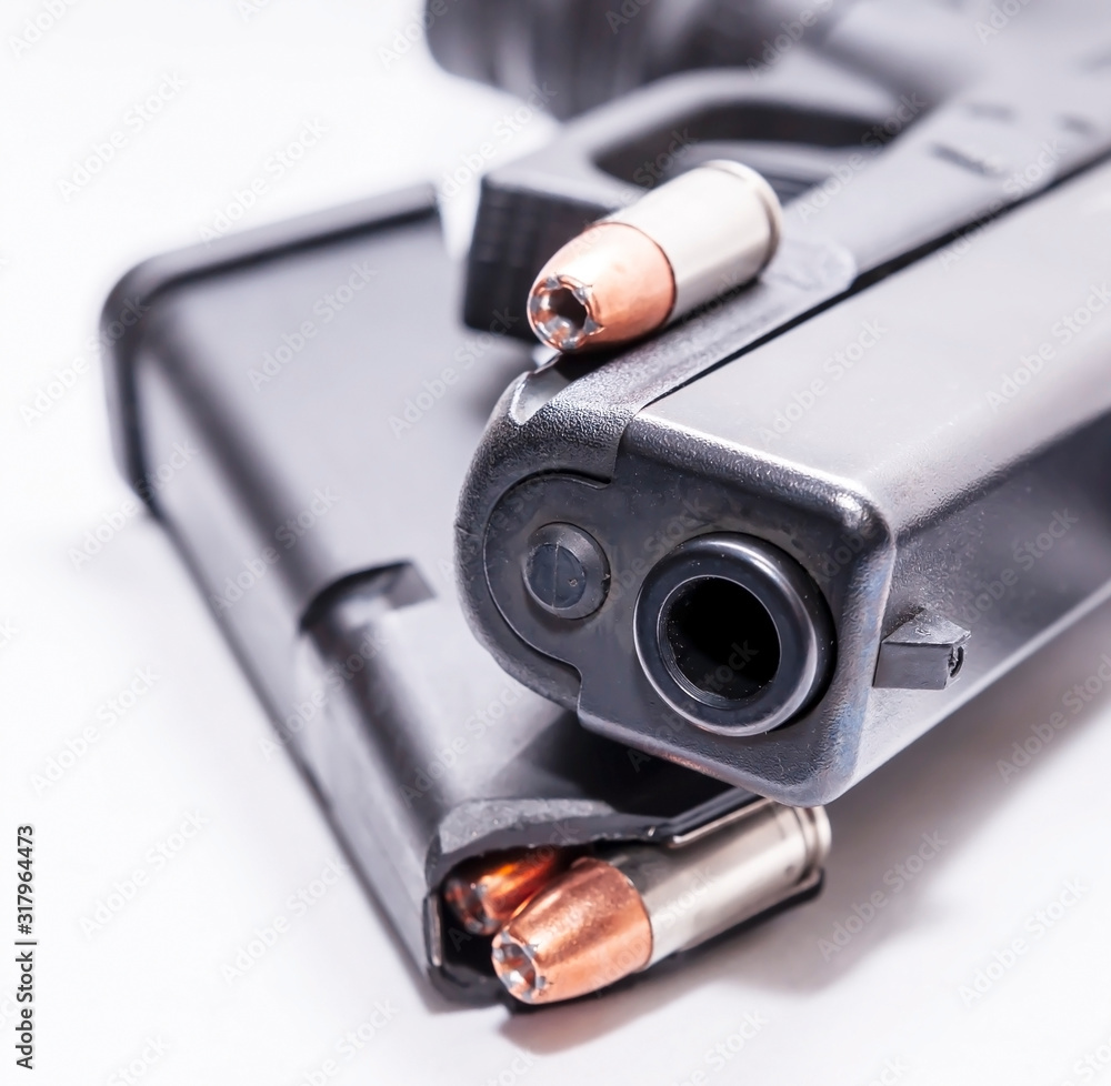 A black 9mm semi automatic pistol with a loaded pistol magazine with a ...