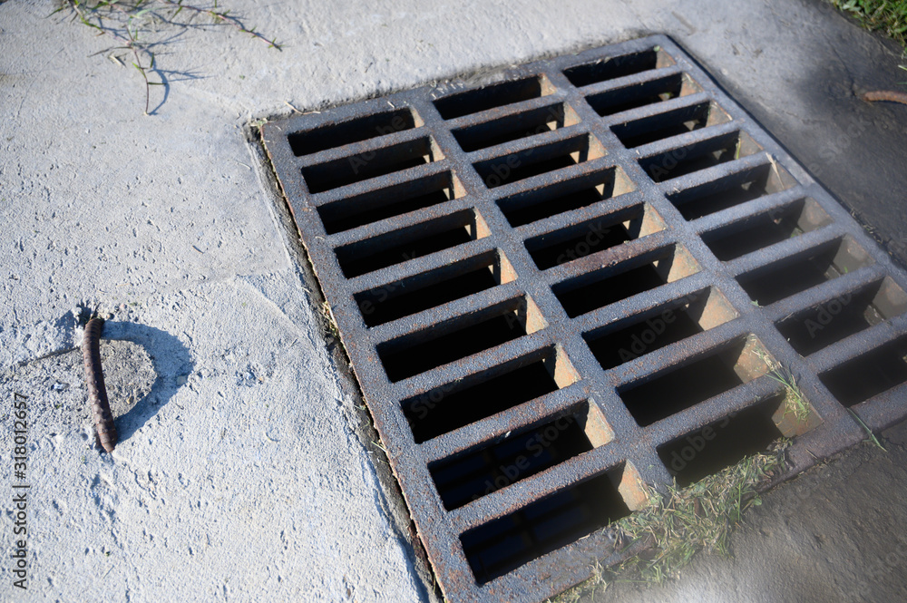 Storm water cast iron grate over collection piping Stock Photo | Adobe ...
