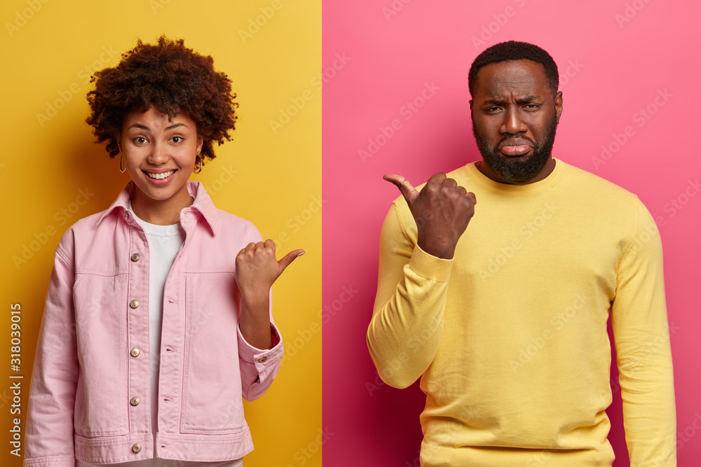Foto de Studio shot of cheerful black woman and gloomy bearded man ...