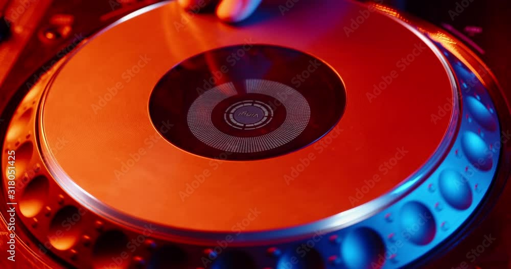Disc jockey working on his professional mixer controller, sliding the ...