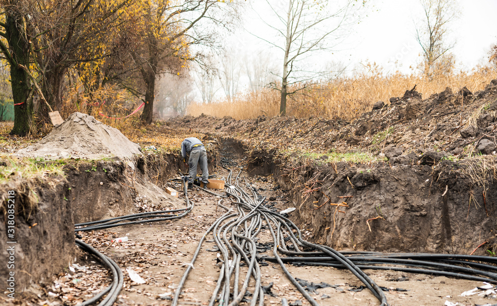 Laying of high-voltage cable lines in the earth trench Stock Photo ...