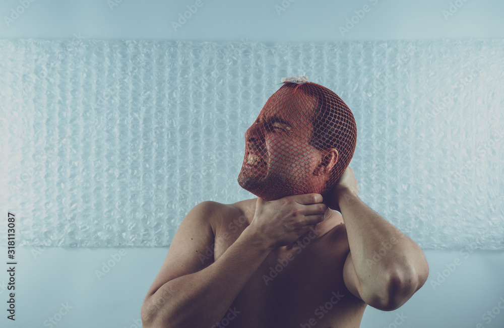 Man Strangling Neck With Netting Against Wall Stock Photo | Adobe Stock