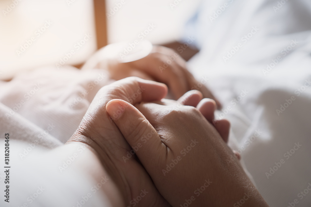 Foto de Hopeful and Sad emotional concept, Couple women hold hands ...