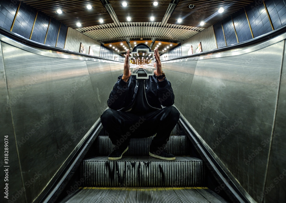 Headless Man Sitting On Escalator Stock Photo | Adobe Stock