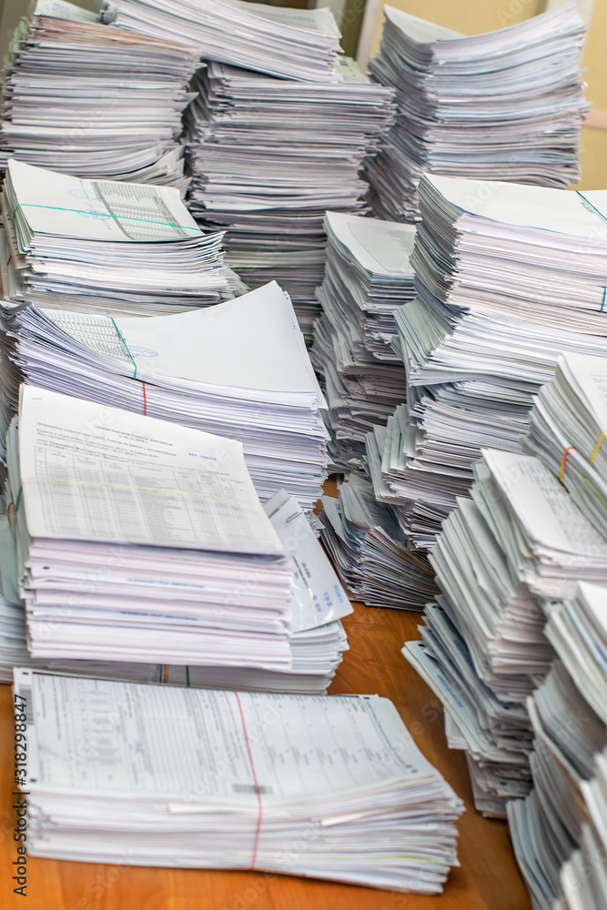 bundles bales of paper documents. stacks packs pile on the desk in the ...