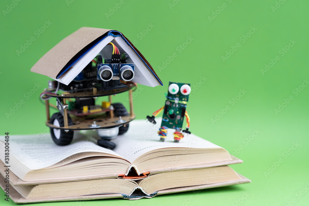 Hand made robot working on the arduino platform with books. Green ...