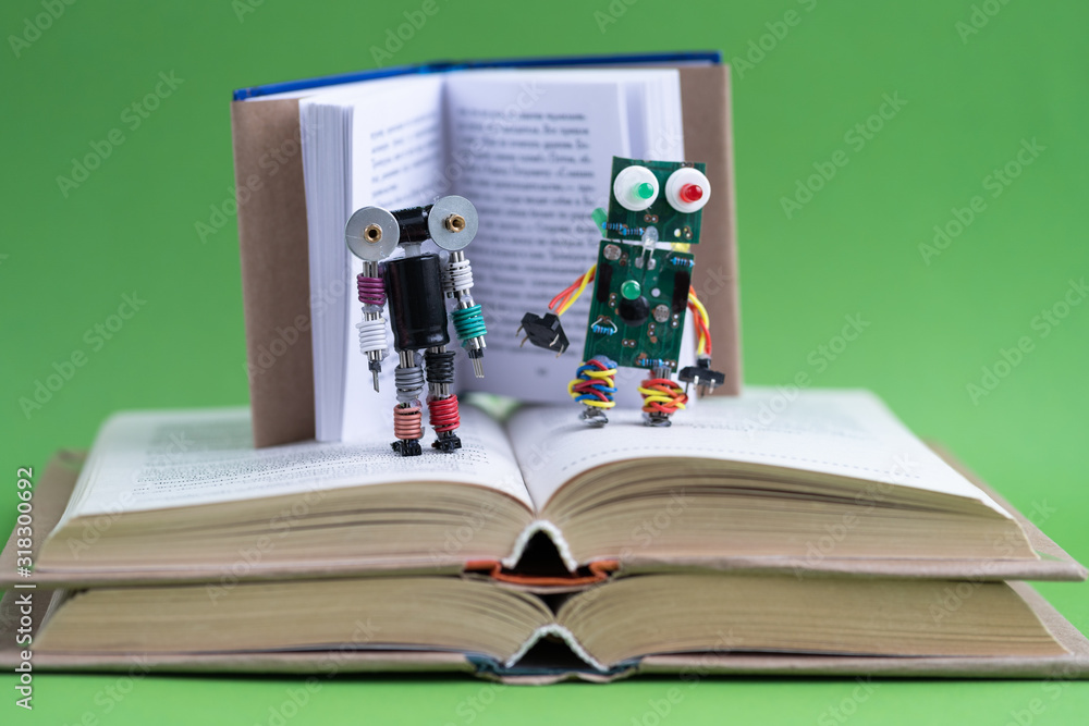 Hand made robot working on the arduino platform with books. Green ...