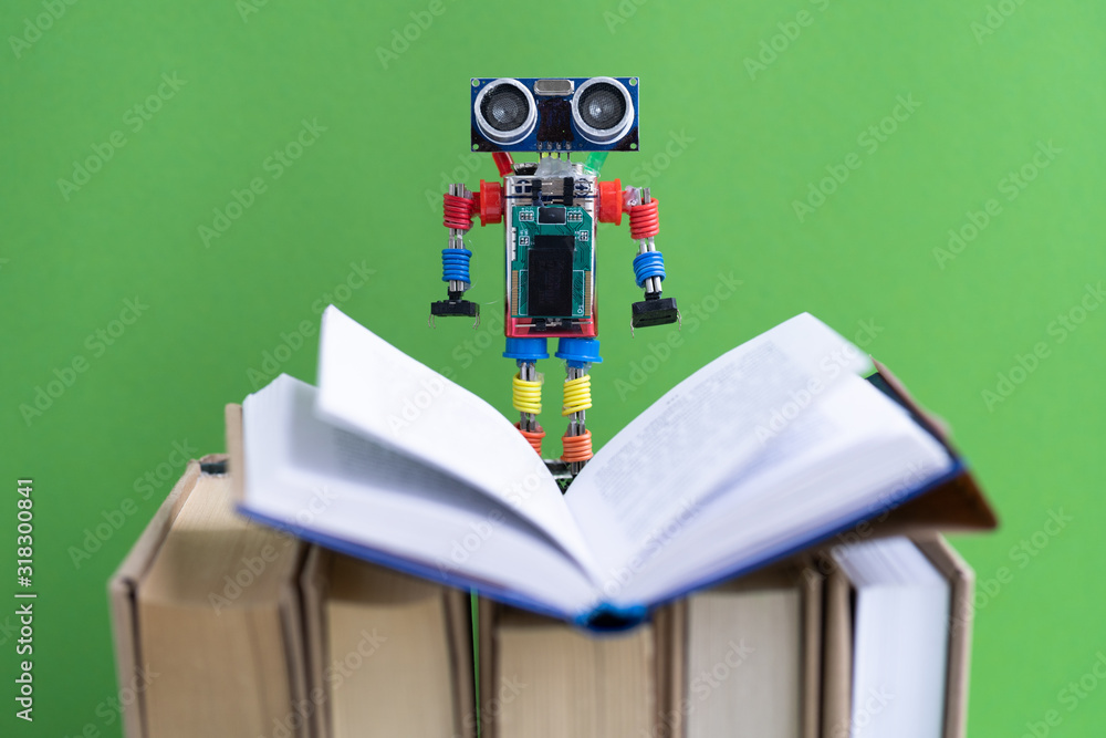 Hand made robot working on the arduino platform with books. Green ...