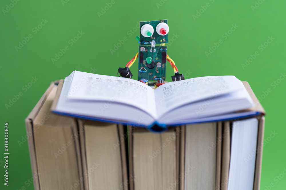 Hand made robot working on the arduino platform with books. Green ...