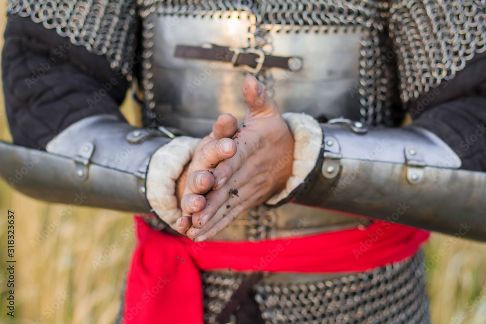 hands of a medieval warrior, close-up, stained with earth. Holds the ...
