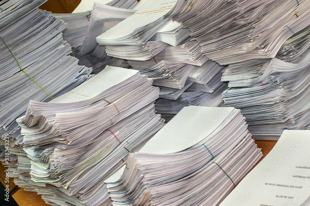 bundles bales of paper documents. stacks packs pile on the desk in the ...