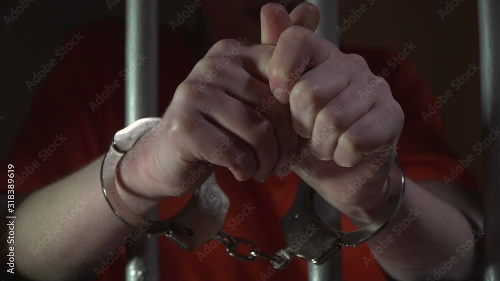 Female Prisoner behind bars in A Jail / Prison Cell. She is in ...