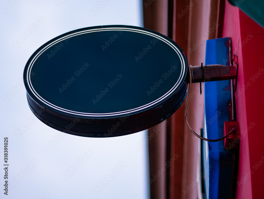Oval real sign on wall of building. Dark blue rounded signboard of cafe ...
