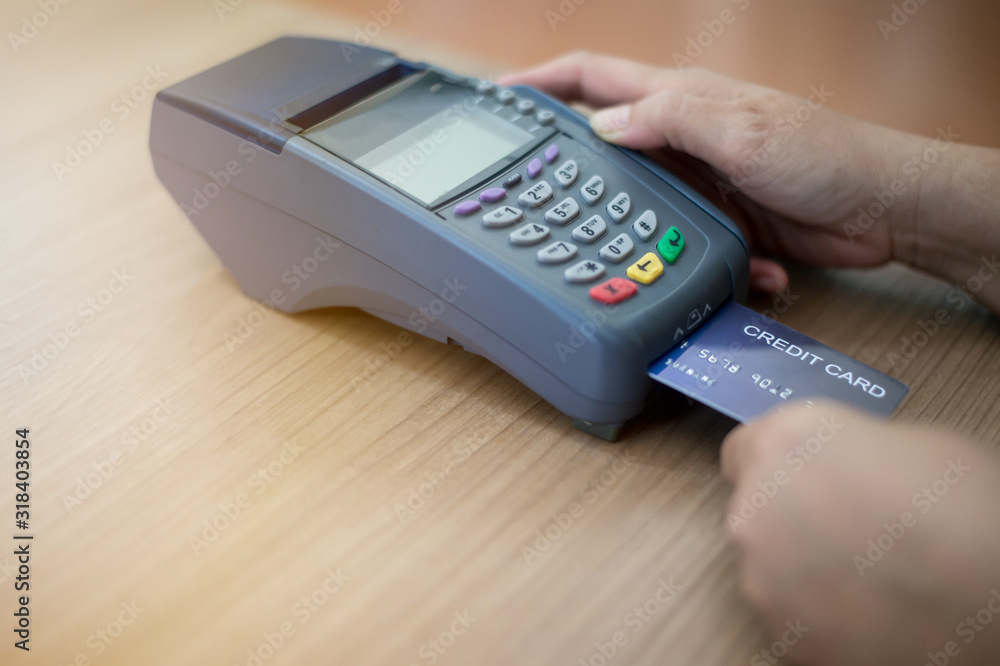 Close-up, focusing on capturing credit card payments, swiping credit ...