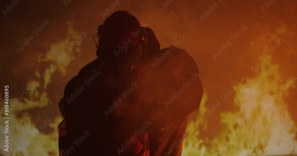 Firefighter saves a girl from the fire Stock Video | Adobe Stock