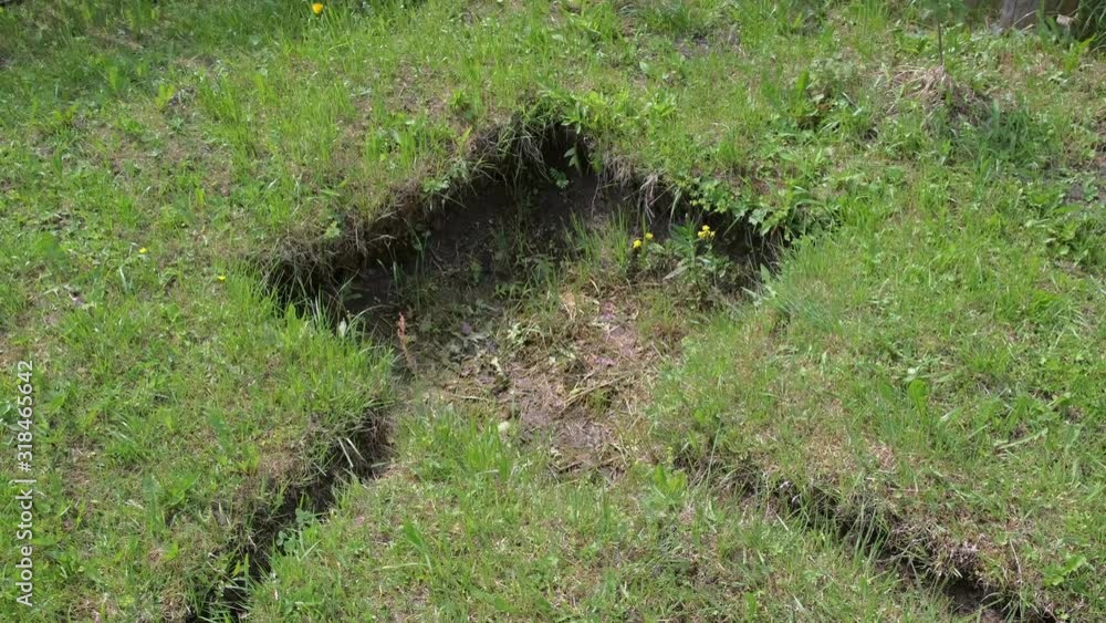 Pits with ditches in the ground to drain water on the plot in the ...