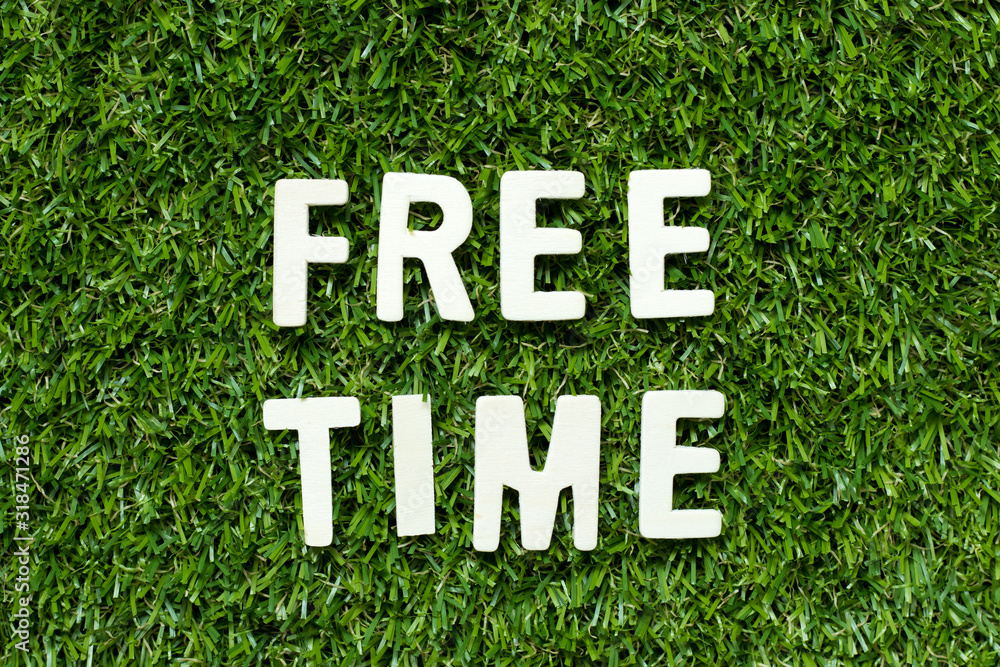 Alphabet letter in word free time on artificial green grass background ...