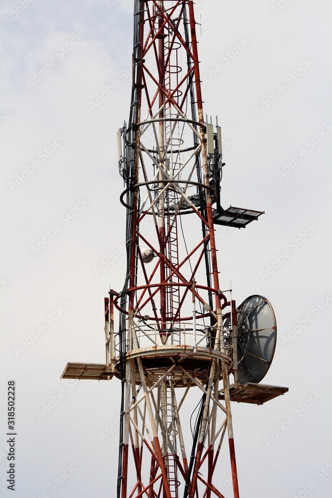 Middle part of strong tall cell phone red and white antenna tower with ...