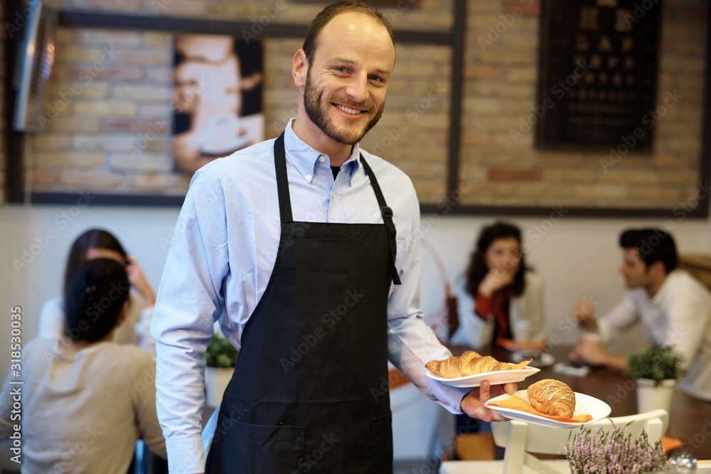 Portrait of happy waiter Stock Photo | Adobe Stock