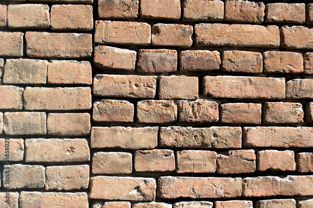 Part of the brick wall in the old town. Different bricks, whole and ...