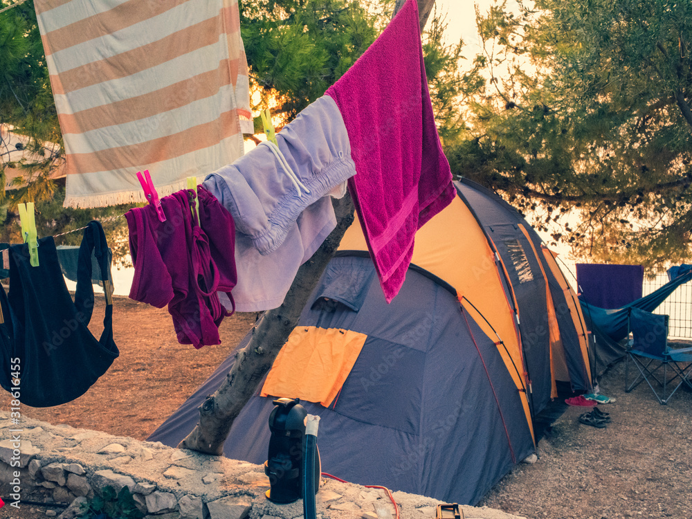 Travel tent, clothes on a clothesline. Morning at the campsite. Lodging ...