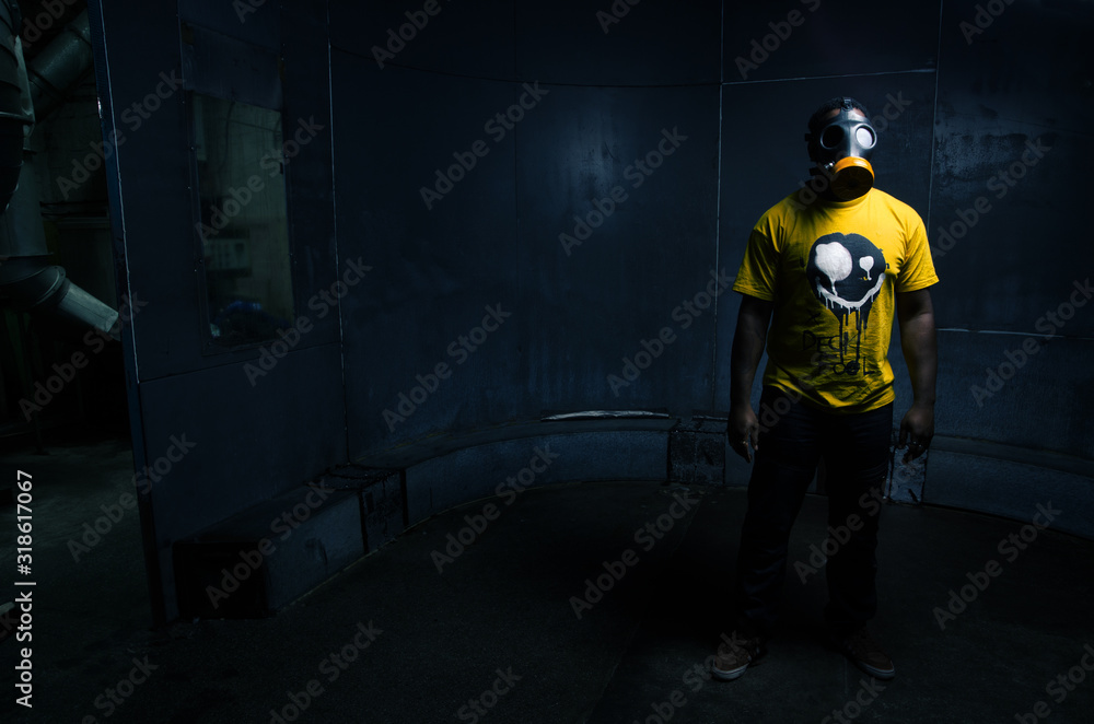 A scary man with reflection eyes in an industrial setting wearing a ...