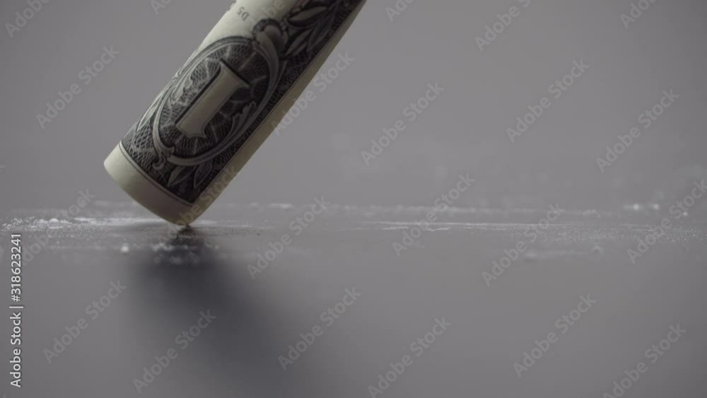 Drug Abuse. A rolled banknote snorting a line of cocaine powder ...